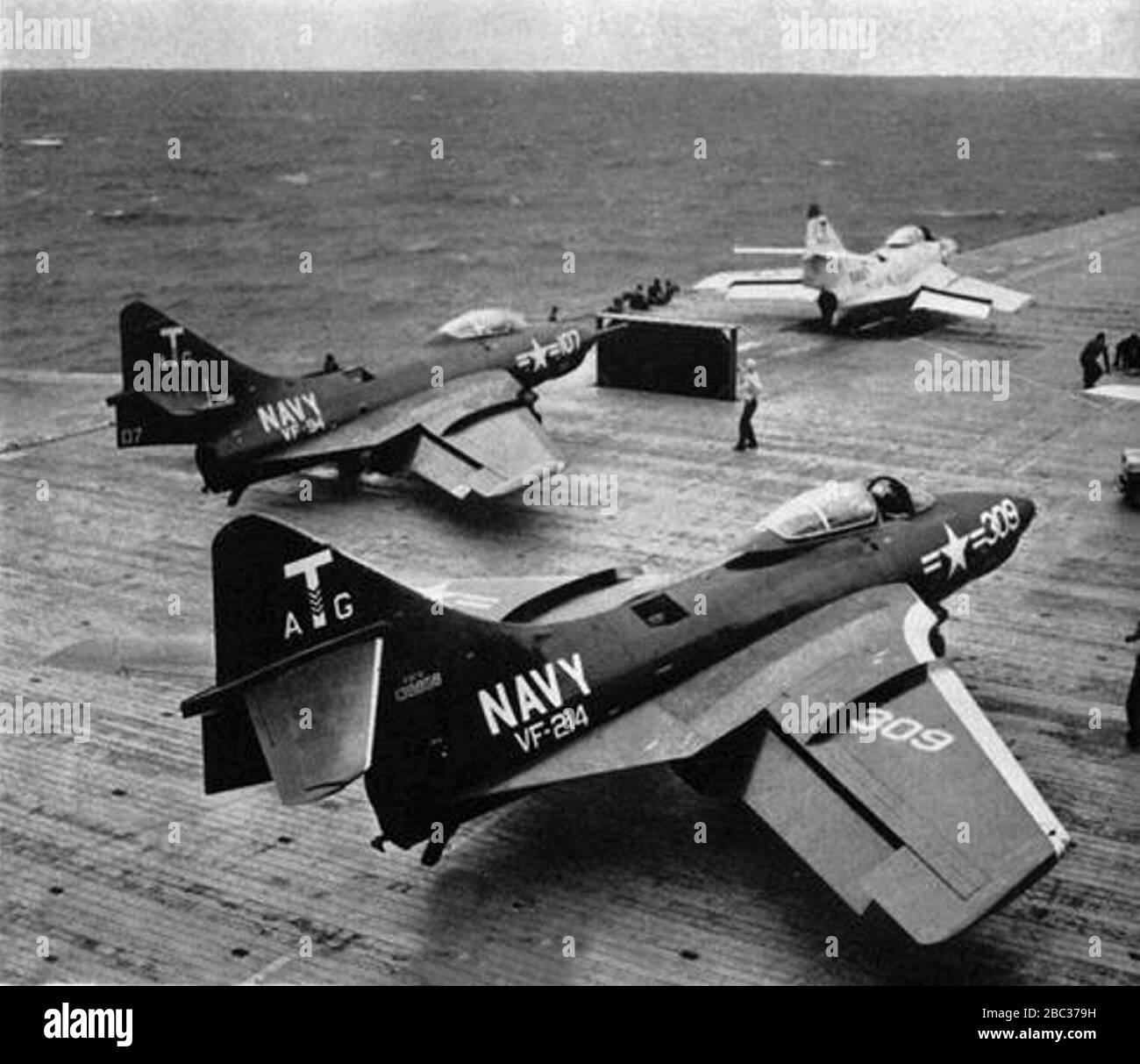 Grumman F9F-8 Cougars of VF-214 and VF-94 are launched from USS ...