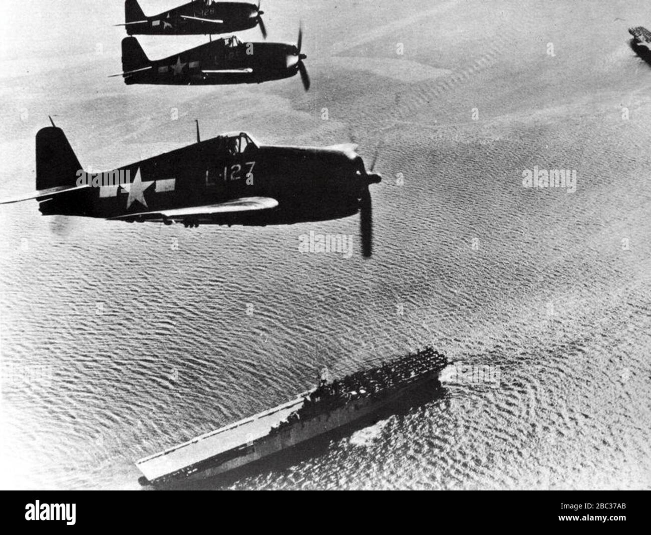 Grumman F6F-5P Hellcats of VF-7A fly over USS Leyte (CV-32), circa in ...