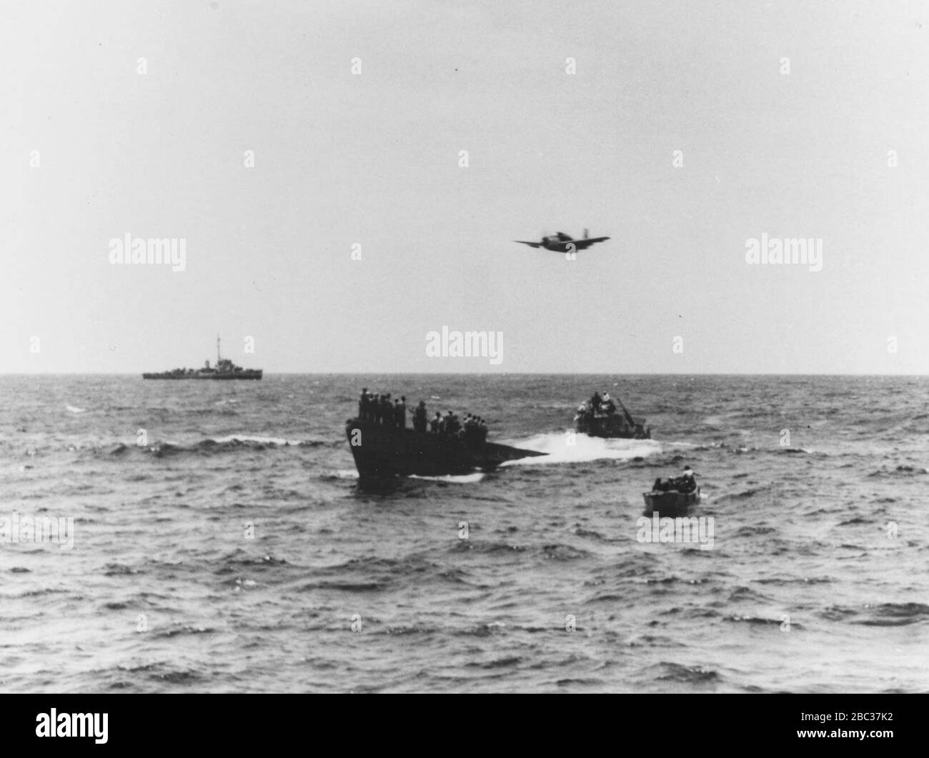 Grumman TBM Avenger of VC-8 flies over the captured German submarine U ...