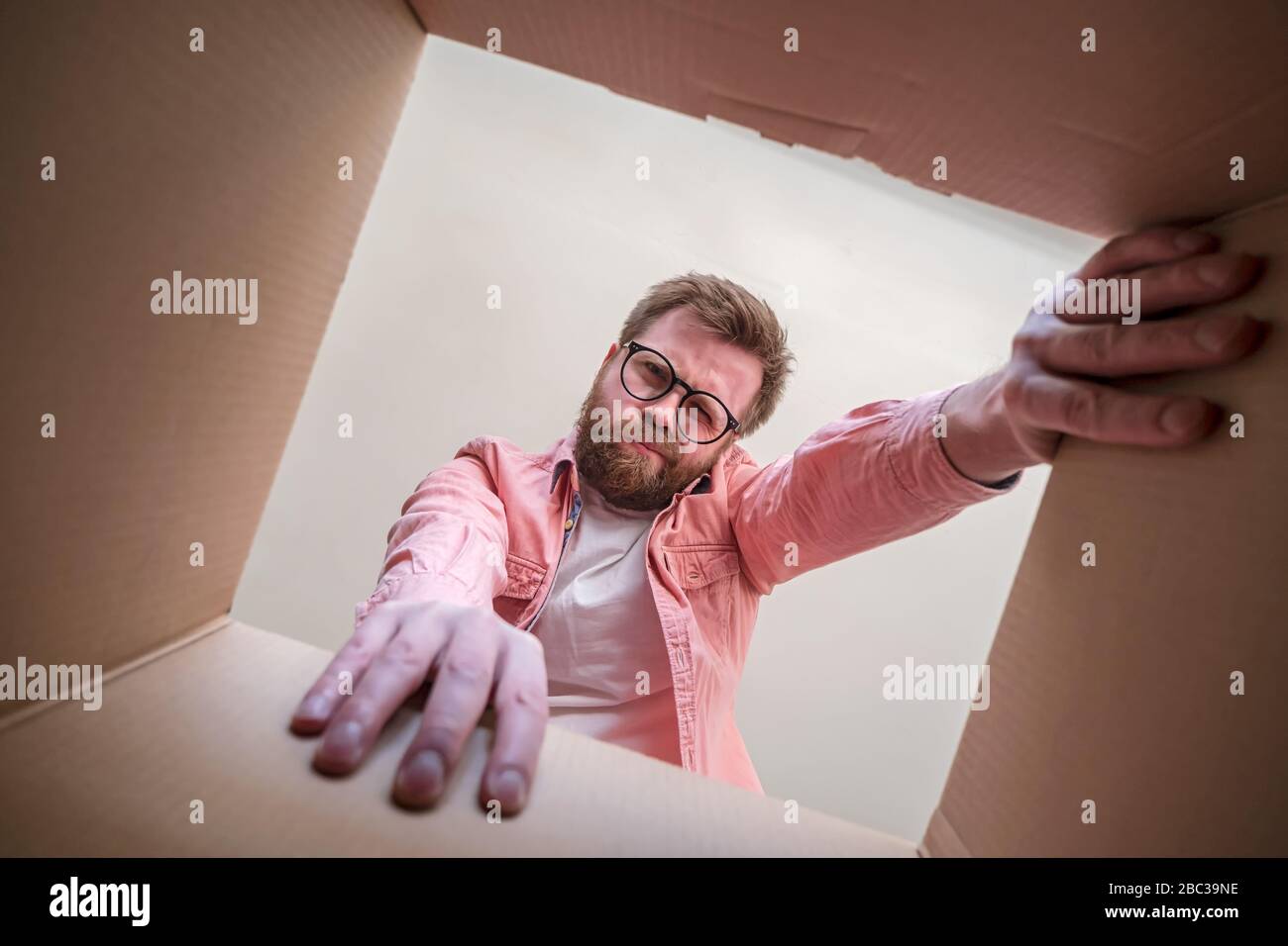 Attractive package delivery man hi-res stock photography and images - Alamy