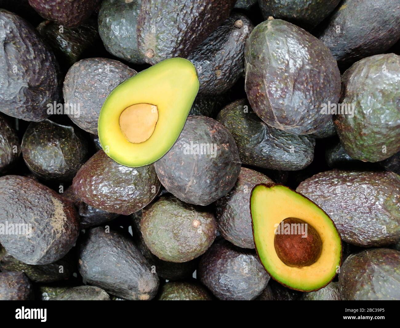 top view of mexican avocados, whole and cut in half Stock Photo - Alamy