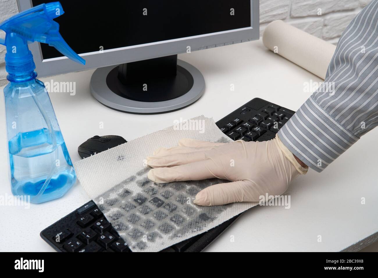 concept of cleaning or disinfecting the office - a businessman cleans ...