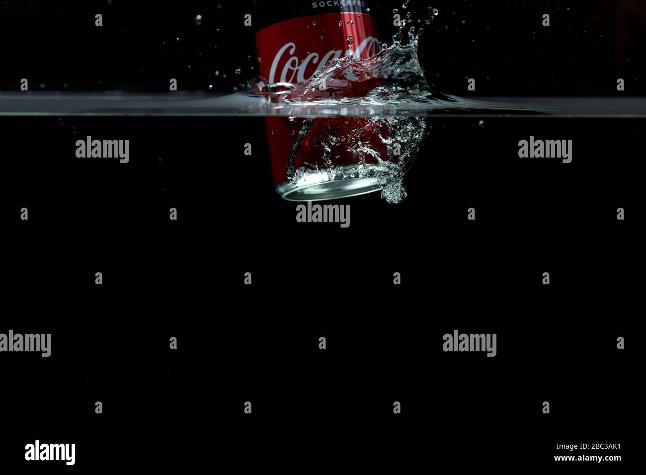 Close up view of can falling in water. Coca cola Stock Photo - Alamy