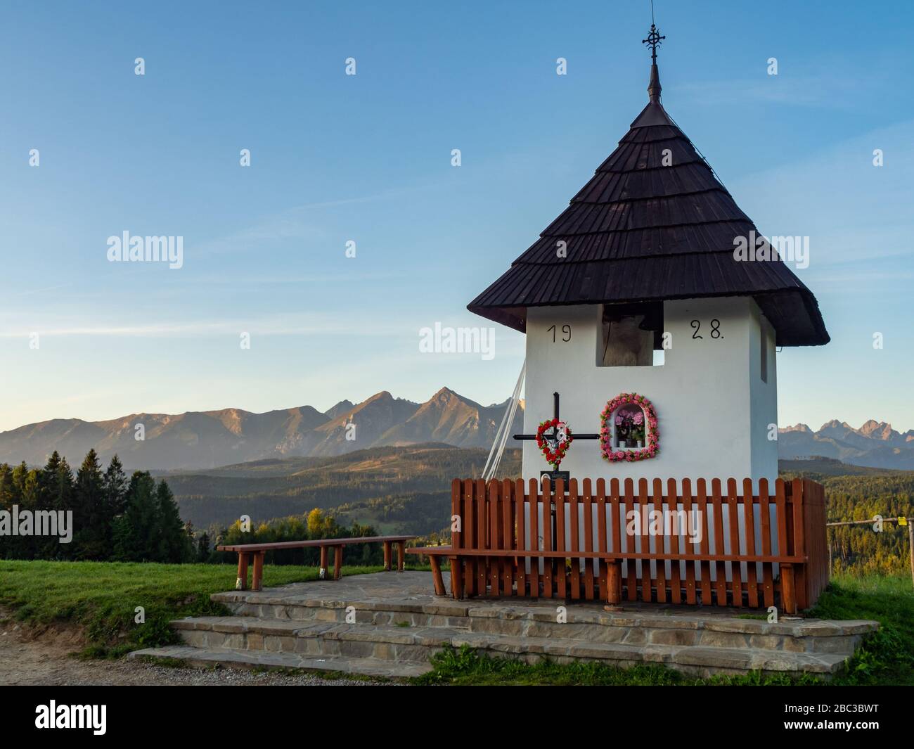 Small chapel on green field with Tatra Mountains in the background ...