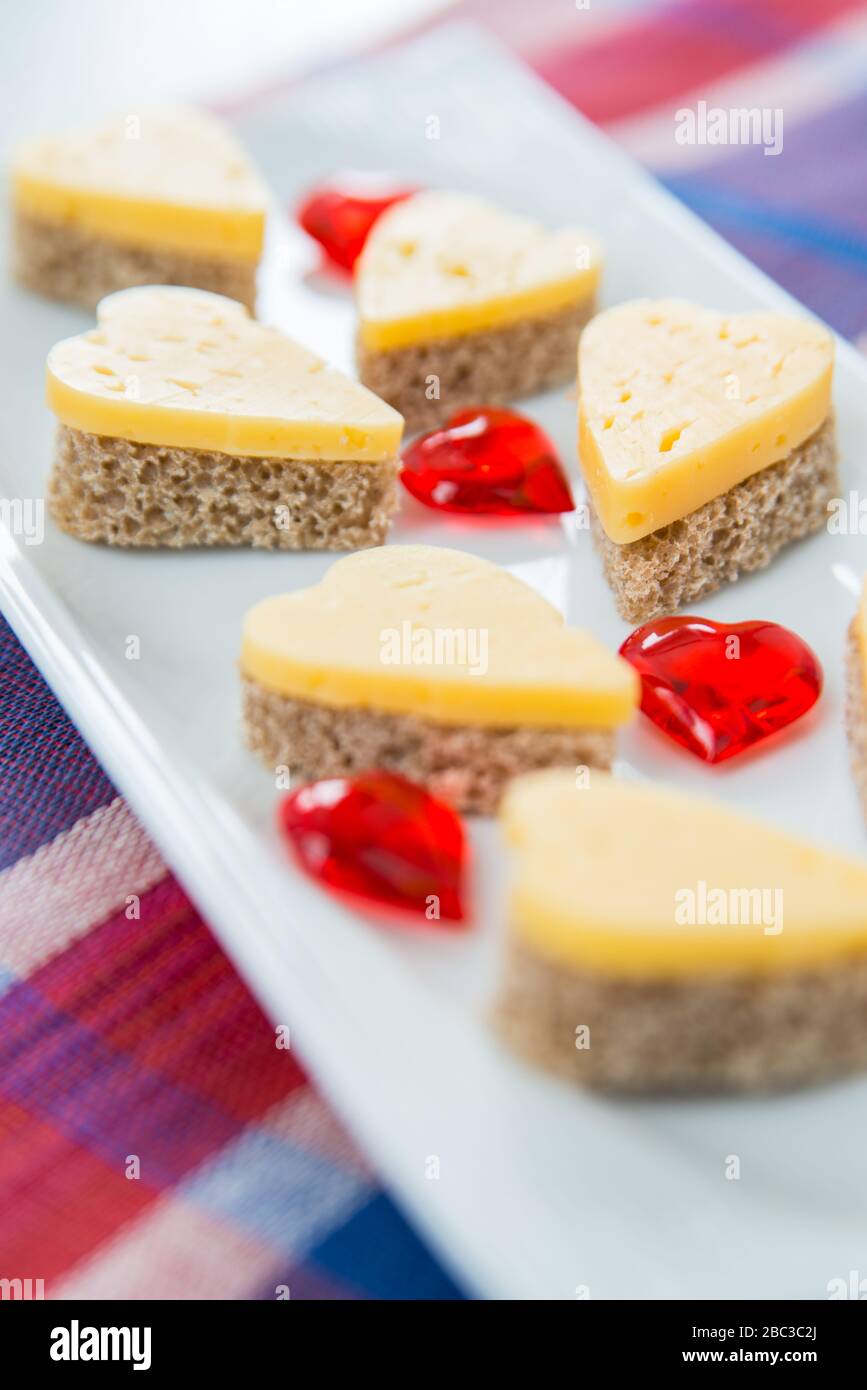 Heart shaped cheese sandwiches on the white plate Stock Photo - Alamy