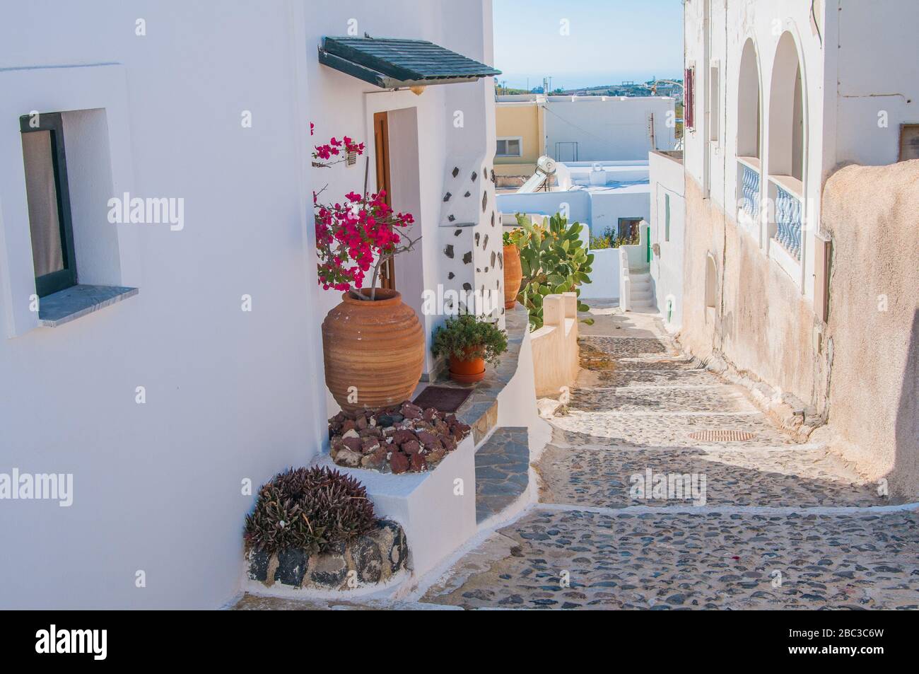 View of the Traditional greek street with white houses Stock Photo - Alamy