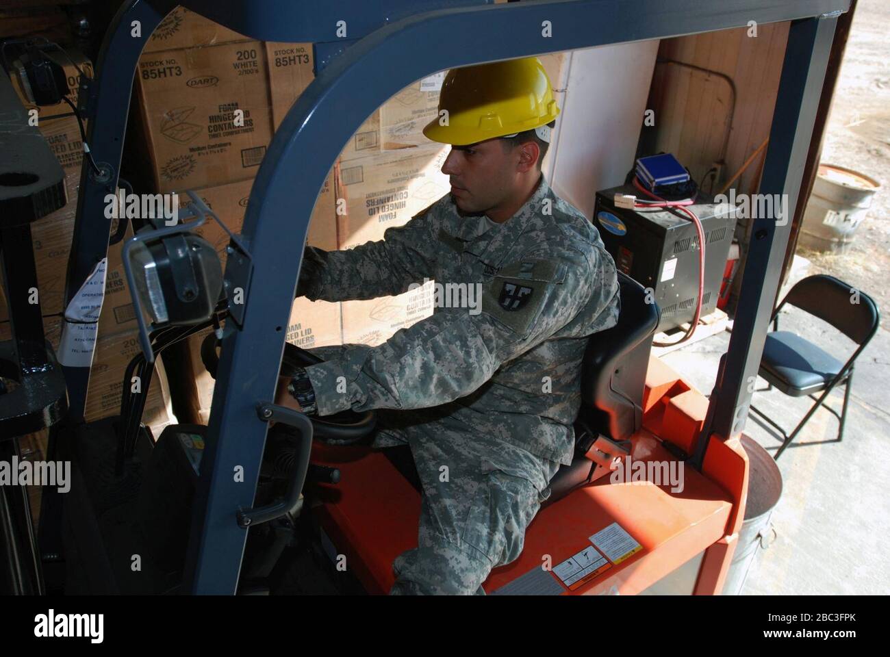 Guard prepares to deliver supplies using a fork lift Stock Photo - Alamy