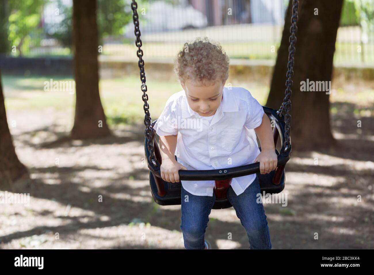 Child absorbed in his childhood world, while playing outdoor Stock ...