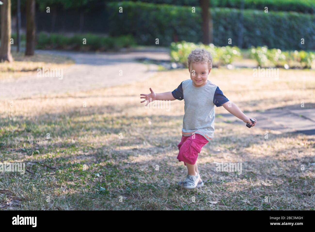 Child absorbed in his childhood world, while playing outdoor Stock ...