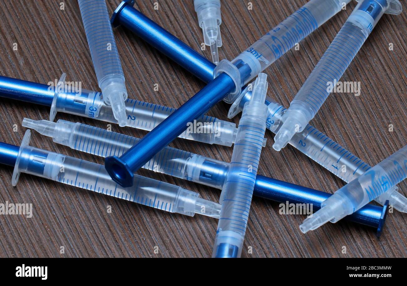 Large pile of plastic medical syringes on wooden background Stock Photo ...