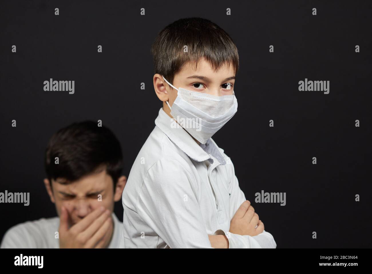 boy in a mask in the background of a sick teen Stock Photo - Alamy