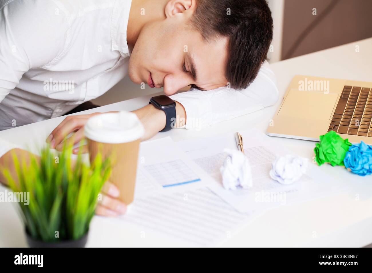 Tired man working at company office at computer Stock Photo - Alamy