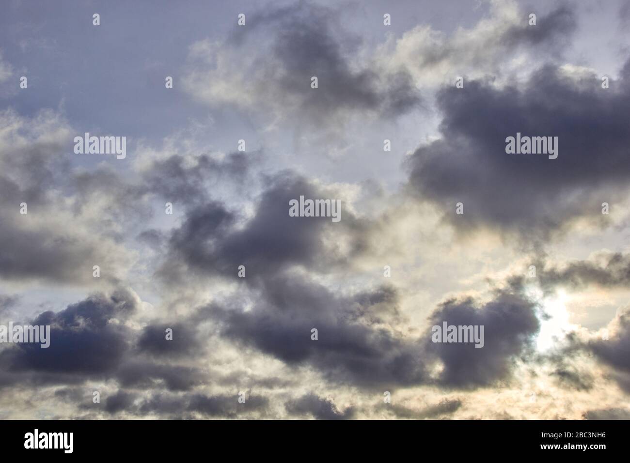 low-floating Cumulus clouds at dawn against a blue sky Stock Photo - Alamy