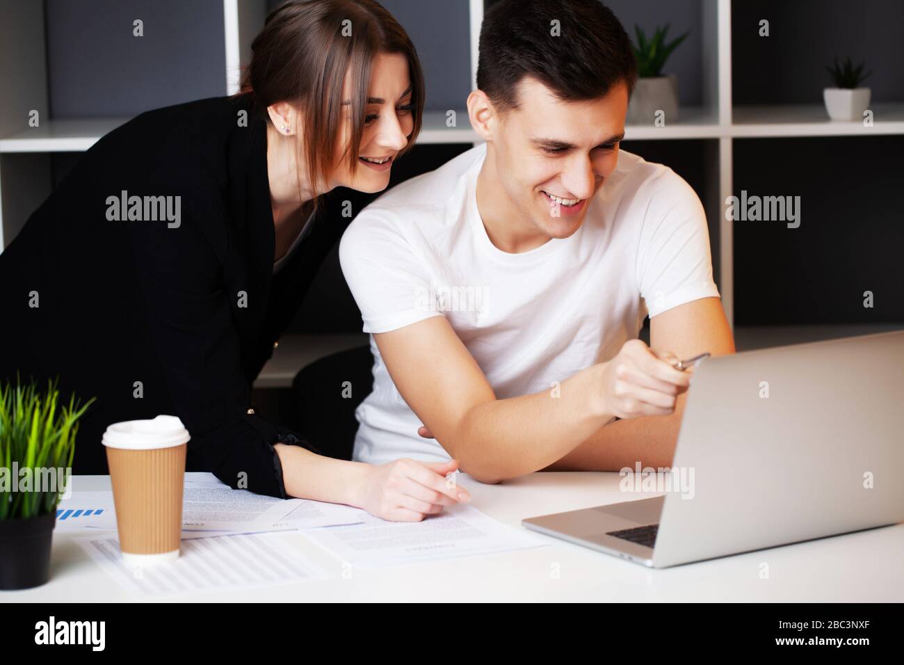 Loving couple working successfully together on their own business in ...