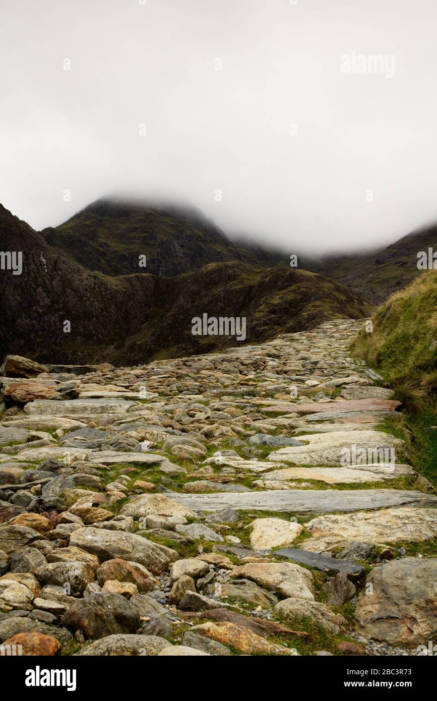 Mountain path leading up into the unknown beyond the clouds Stock Photo ...