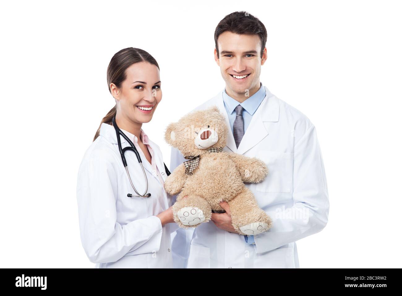 Pediatric doctors holding teddy bear Stock Photo - Alamy