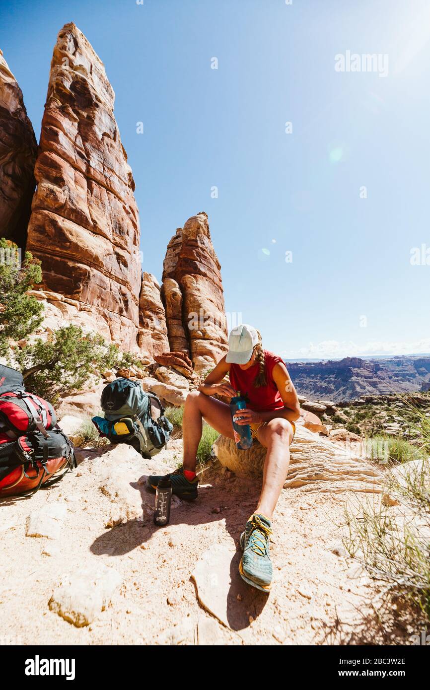 female hiker takes a water break in the hot desert midday sun Stock ...