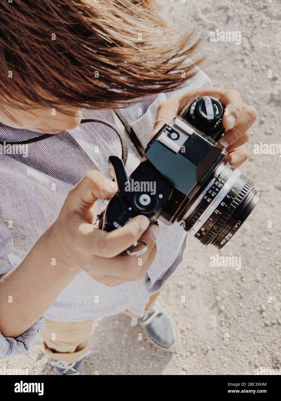 Close up portrait of a kid holding a vintage camera Stock Photo - Alamy