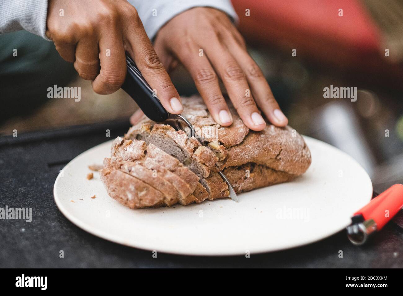 Closeup of women hands cutting bread outdoors Stock Photo - Alamy