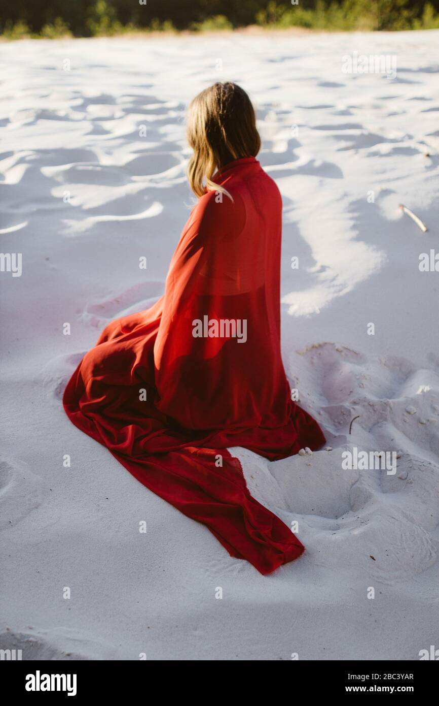 Woman sitting on red sand hi-res stock photography and images - Alamy