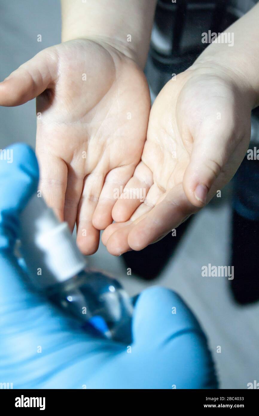 doctor treats children's hands with an antiseptic Stock Photo - Alamy