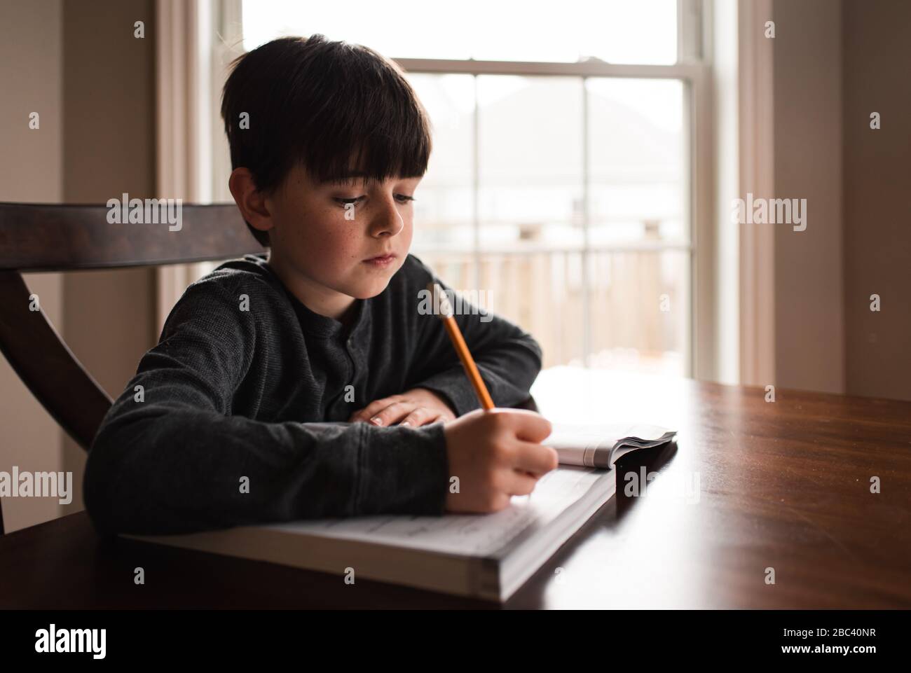 Boy doing his schoolwork hi-res stock photography and images - Alamy
