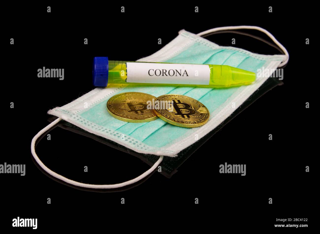 Bitcoin symbolic coin on the face mask isolated on the black background ...