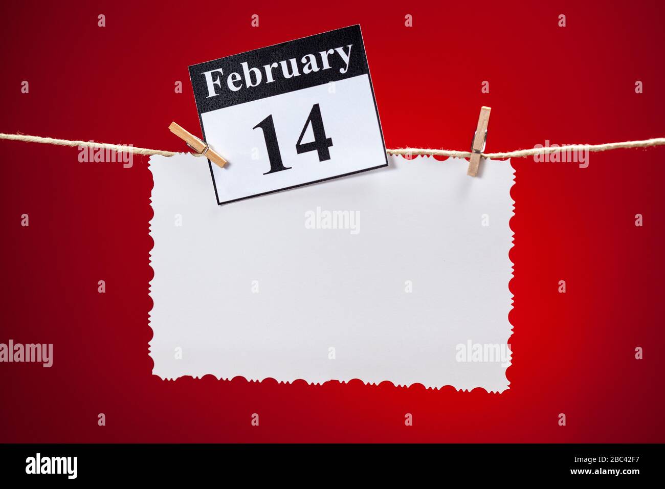 February 14, Valentine's day, white vintage paper over red background ...