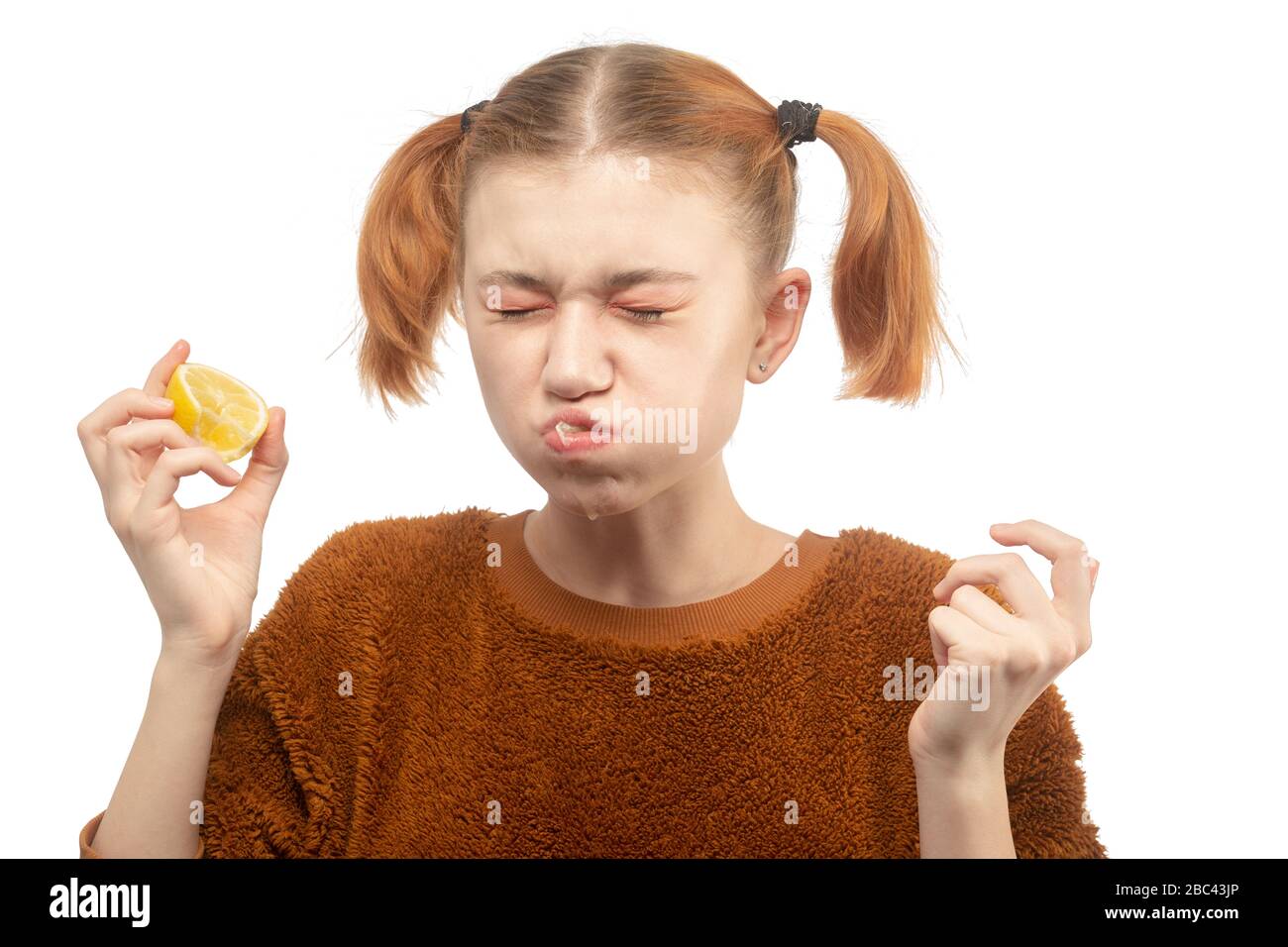 Serious Fun Girl Eats Lemon Isolated On White Background Grimacing