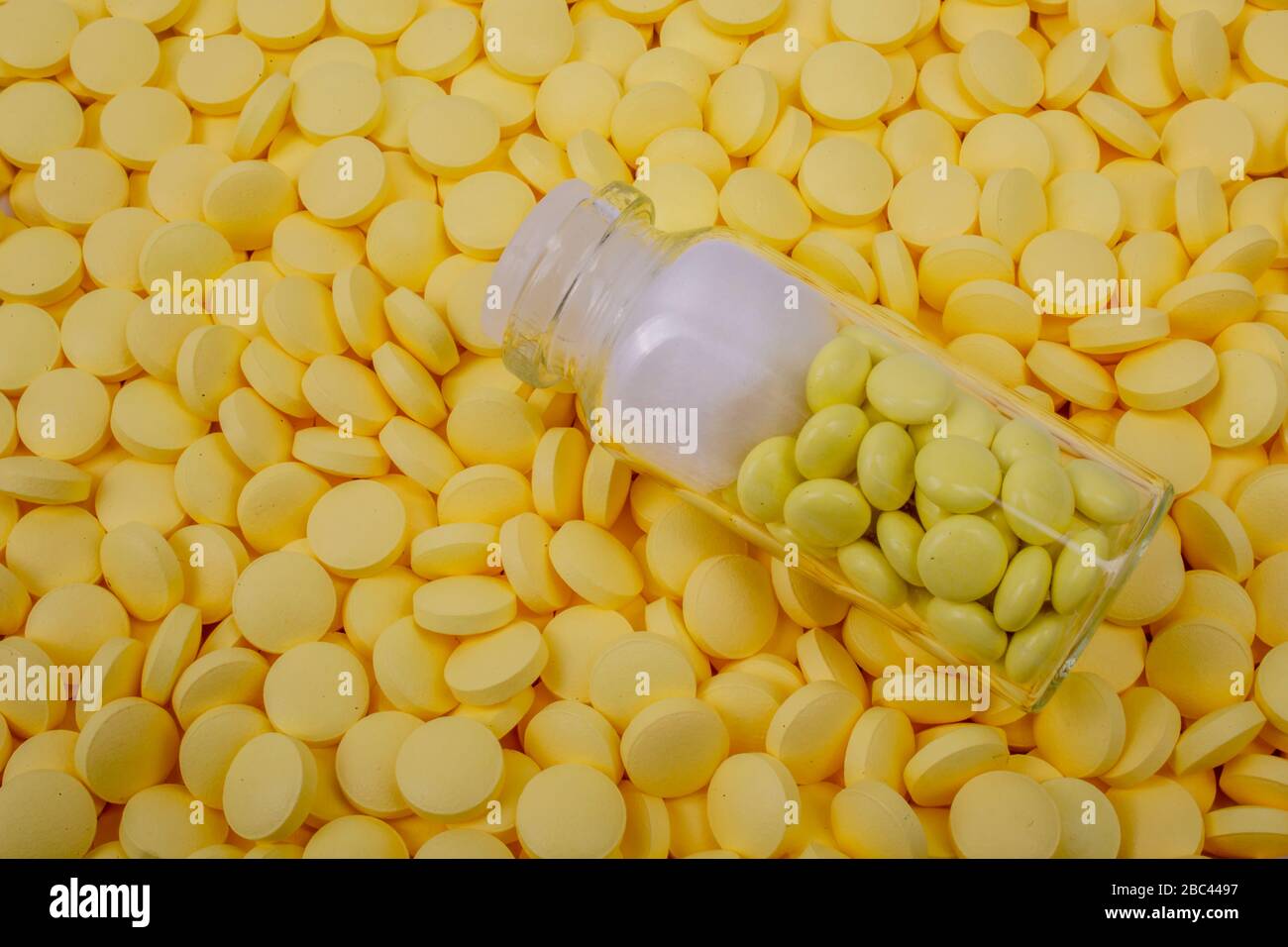 jar of yellow pills lies on other medicines. Drugs, painkillers, colds ...