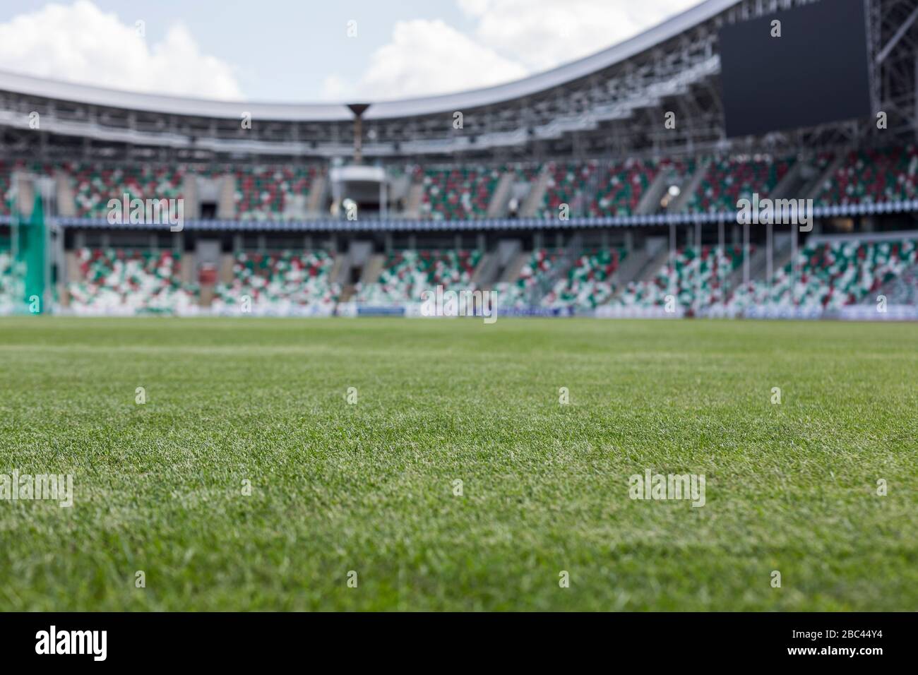 Interior view of green grass field and empty seating Stock Photo - Alamy
