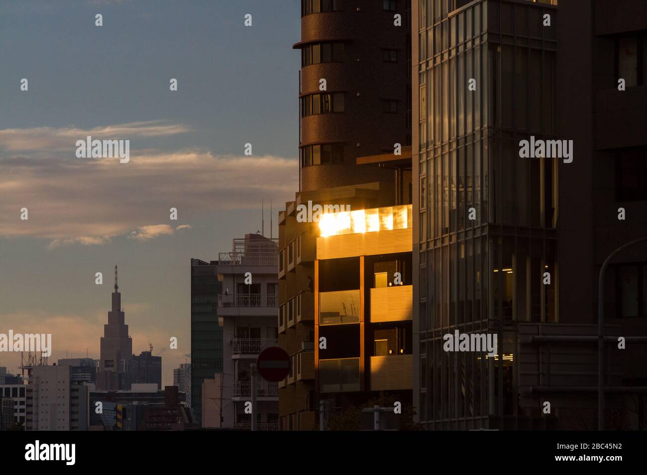 The distinctive NTT Docomo Yoyogi Building in the distance as sunset ...