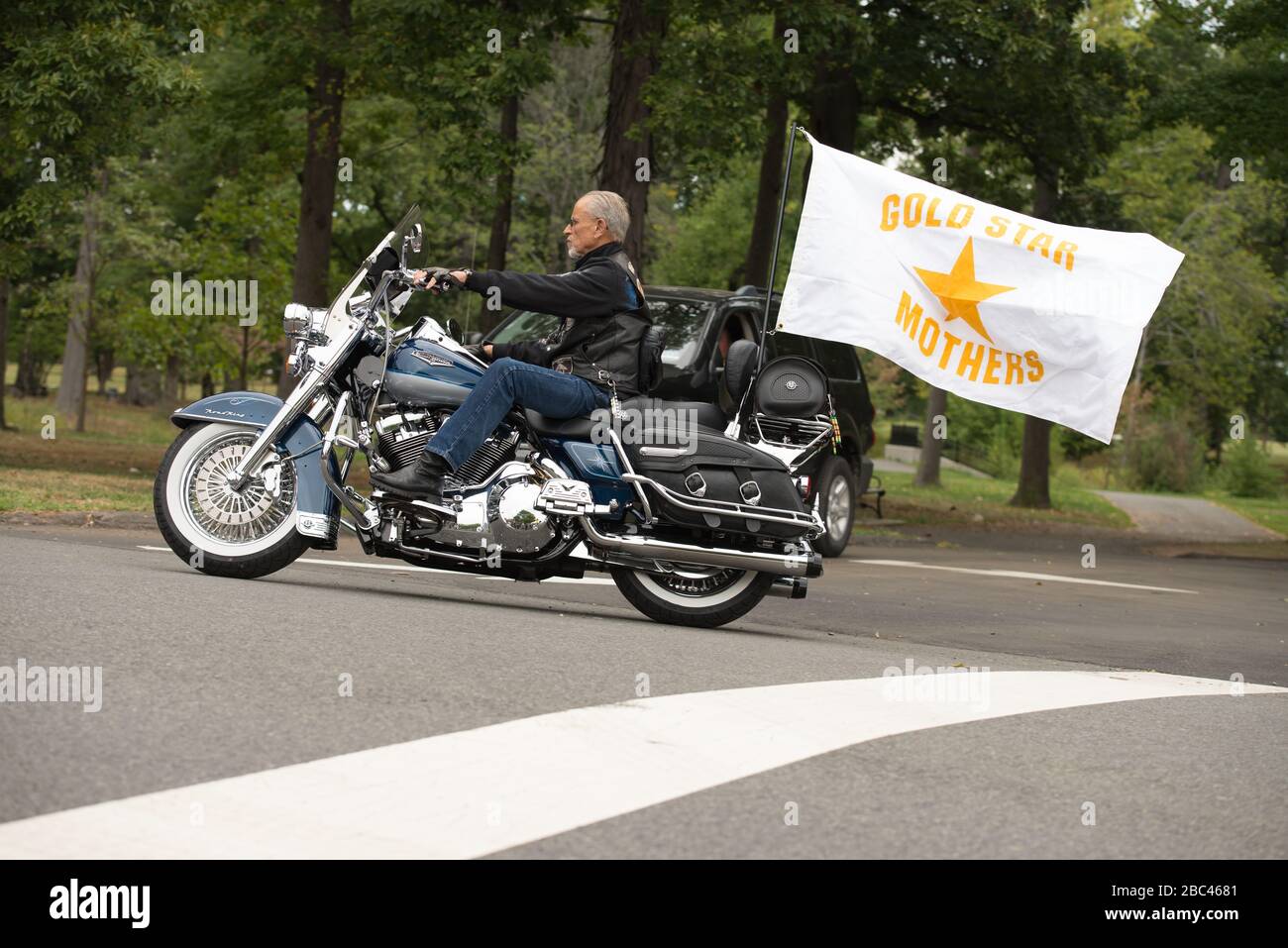 One veteran riding a motorcycle with a Gold Star Mother flag. Gold Star ...