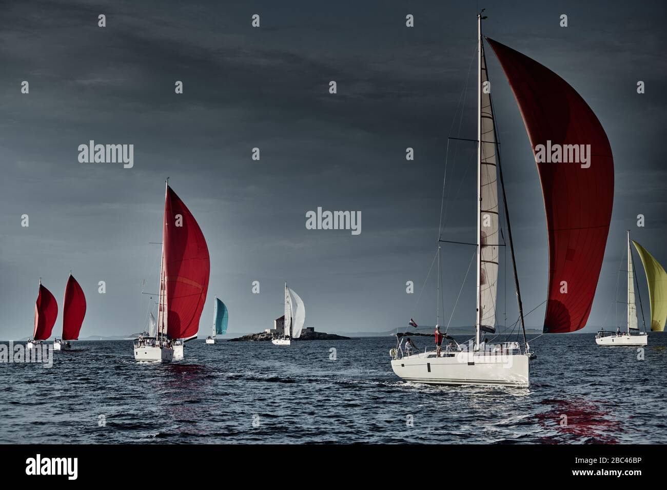 Sailboats compete in a sailing regatta at sunset, sailing race ...