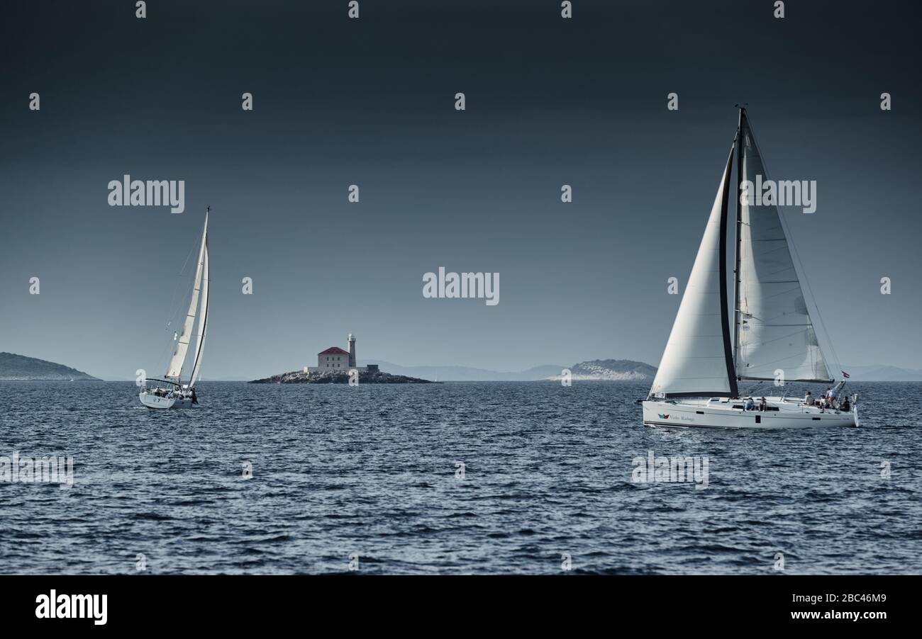 Sailboats compete in a sailing regatta at sunset, sailing race ...