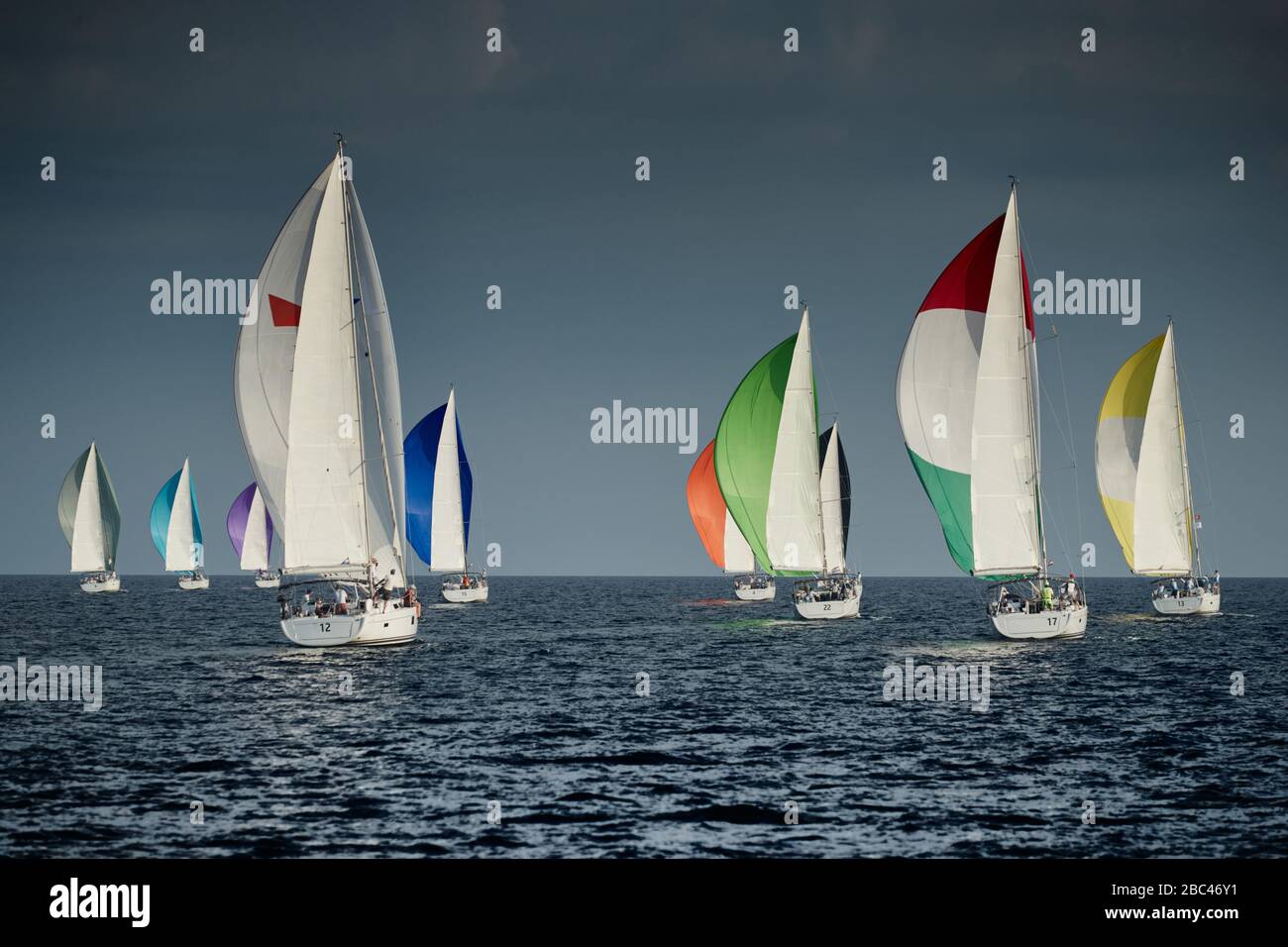 Sailboats compete in a sailing regatta at sunset, sailing race ...