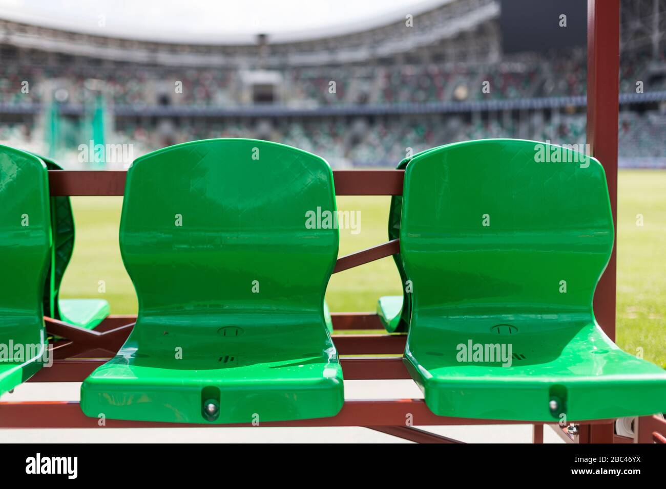 Coach and staff bench, green plastic seats at football stadium Stock ...