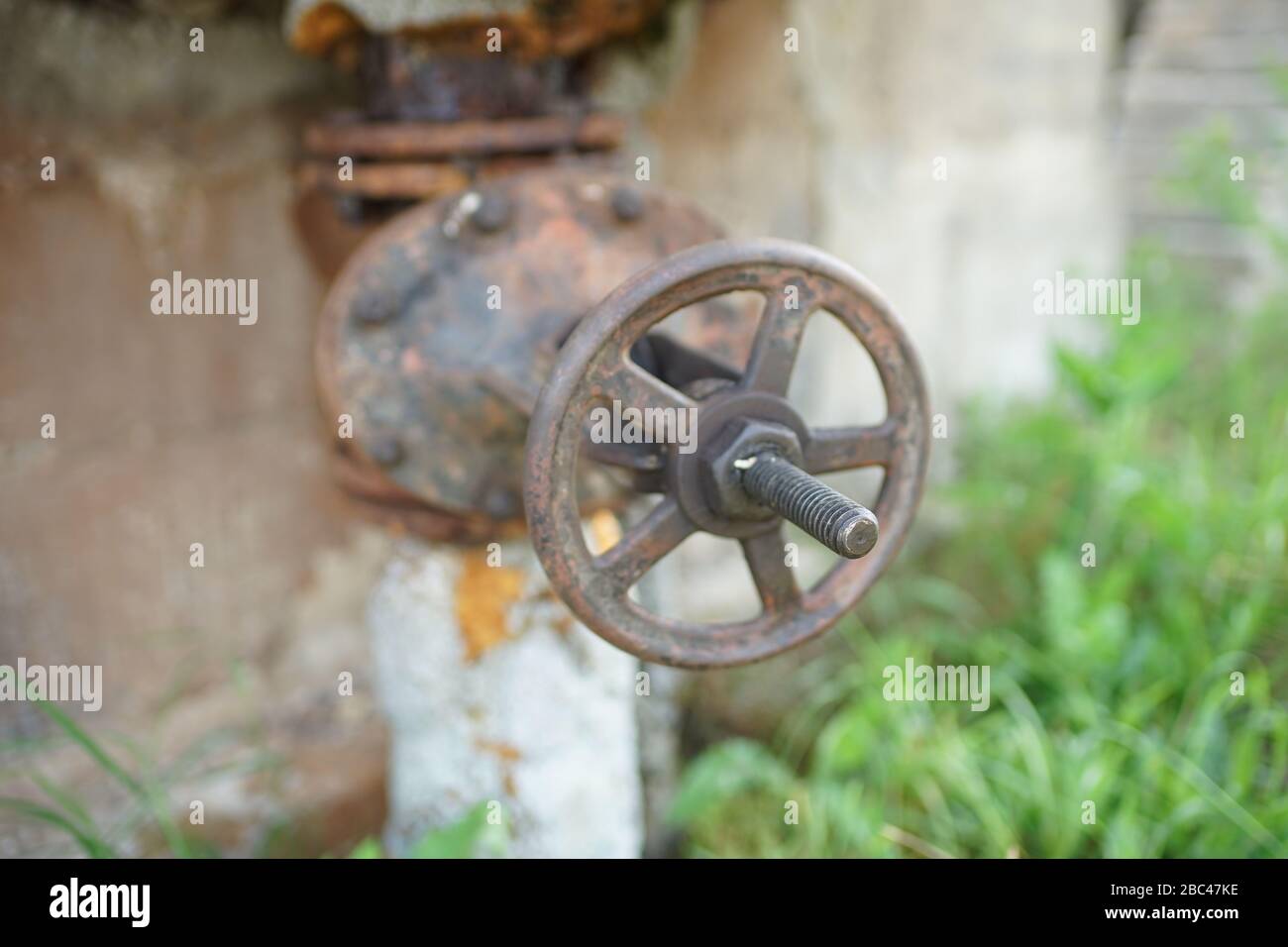 Old round tap of rusty tank closeup, outdoor Stock Photo - Alamy