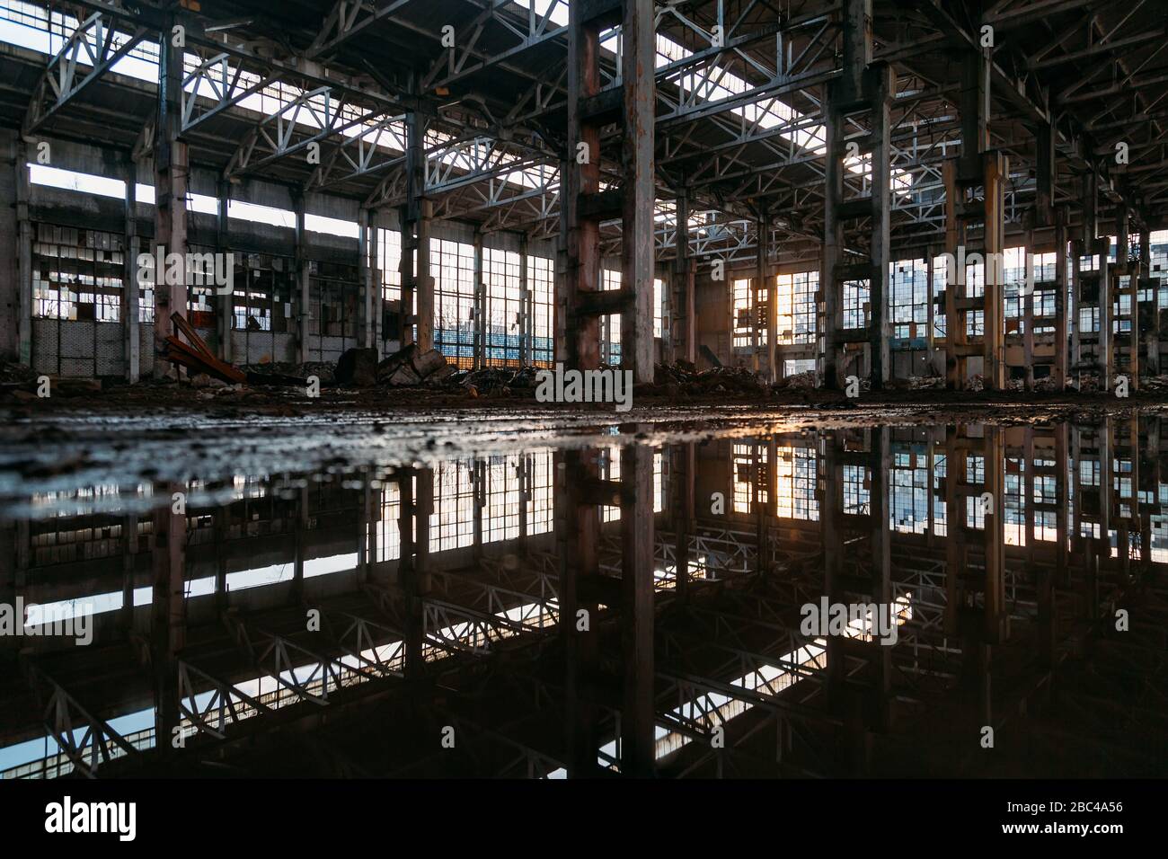 Inside of flooded dirty abandoned ruined industrial building with water ...