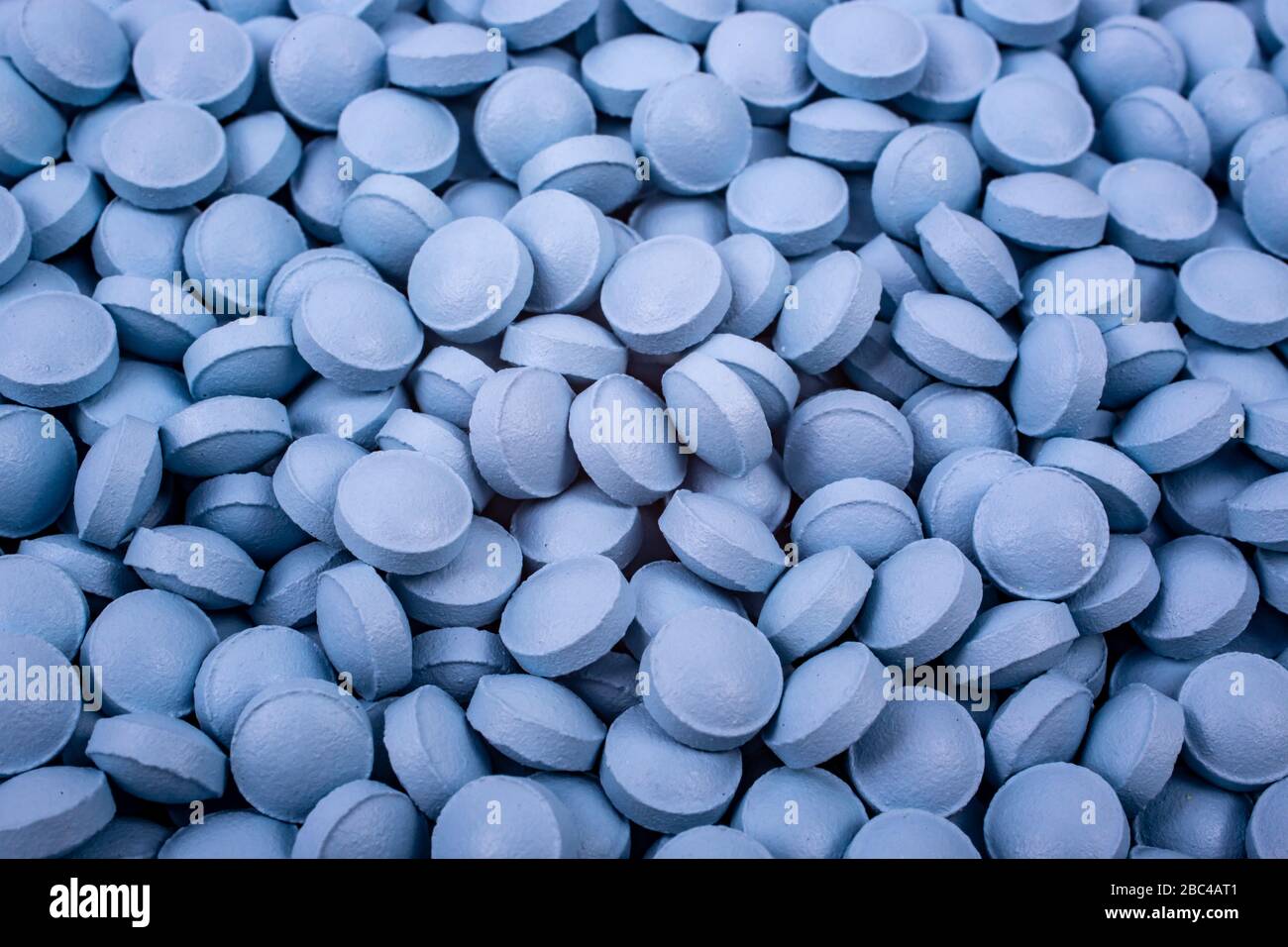 Drugs, painkillers, colds and other medicines. blue pills lie on table ...
