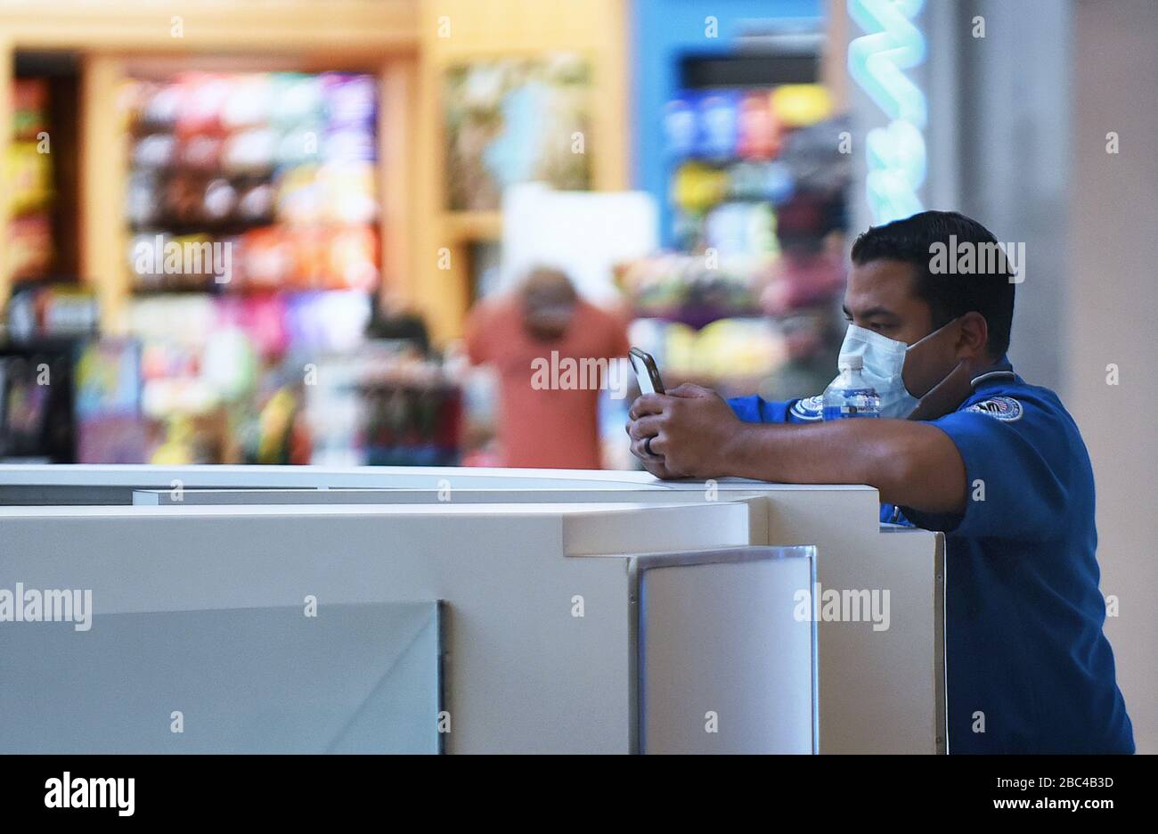 A TSA officer wears a protective mask while taking a break at Orlando ...