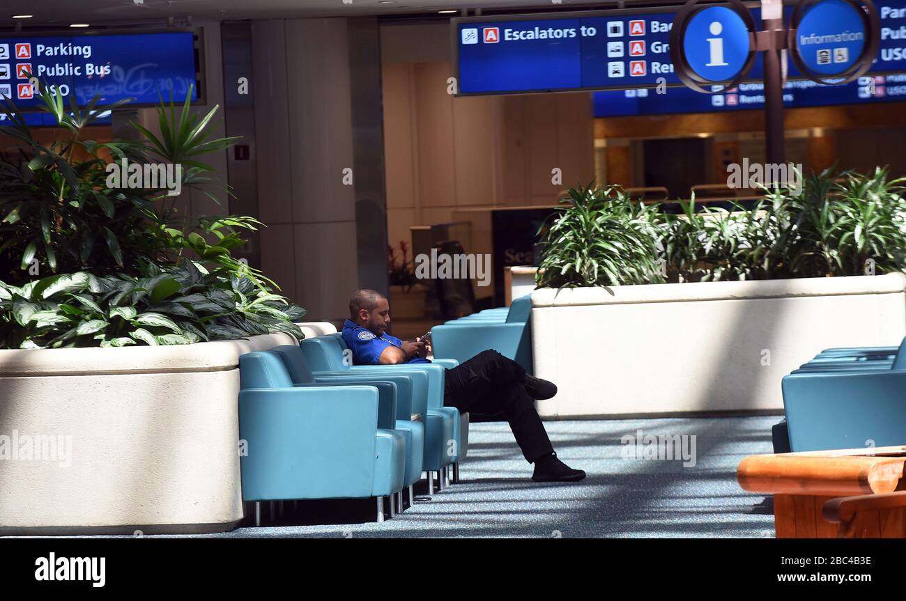 A TSA officer takes a break at Orlando International Airport. In the ...