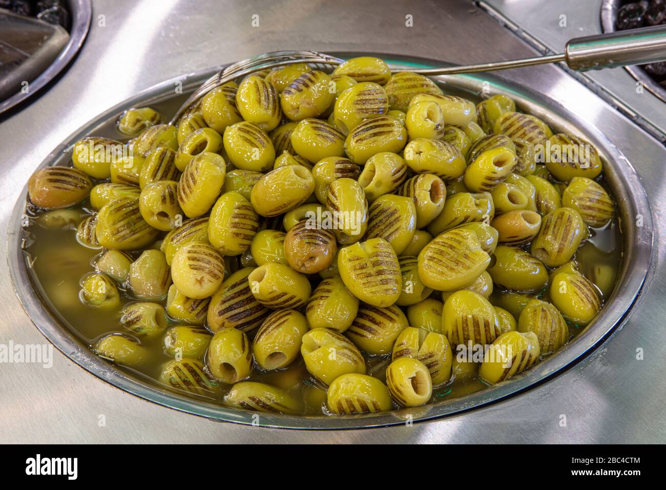 Supermarket olive aisle. Green and black olives in the market Stock ...
