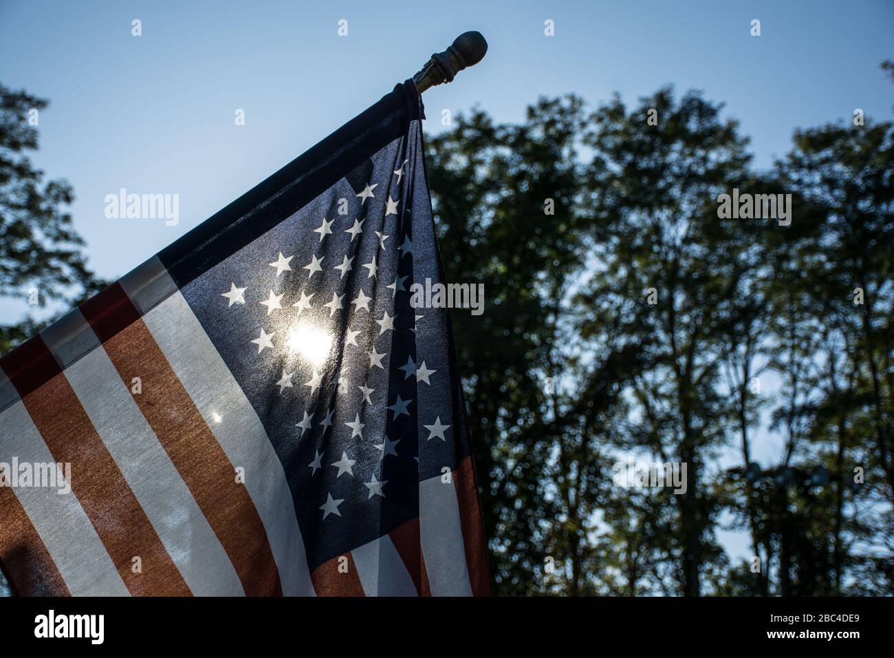 American Flag with the sun behind it Stock Photo - Alamy