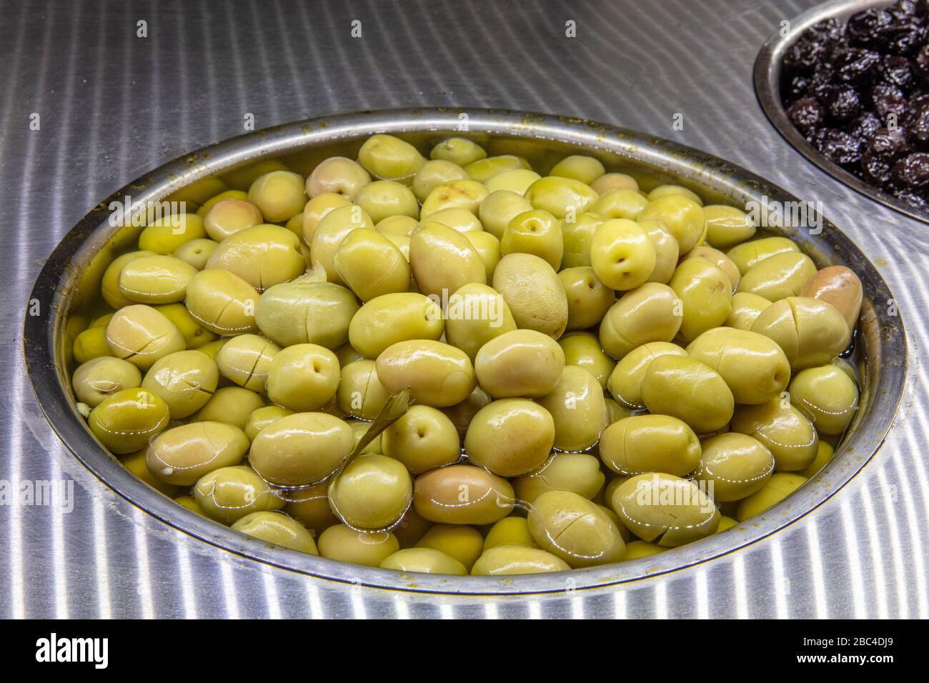 Supermarket olive aisle. Green and black olives in the market Stock ...