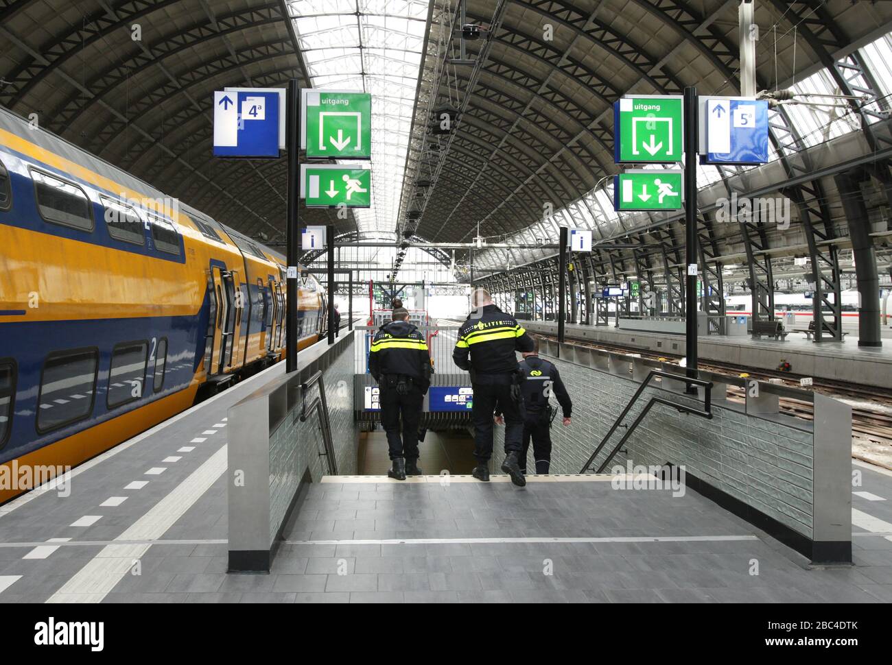 Dutch police officers patrol on empty central station on April 1, 2020 ...