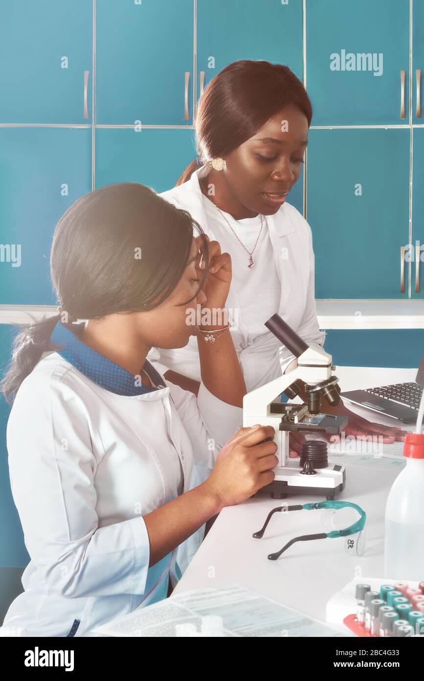 Female African medical students, young graduates or doctors discuss ...