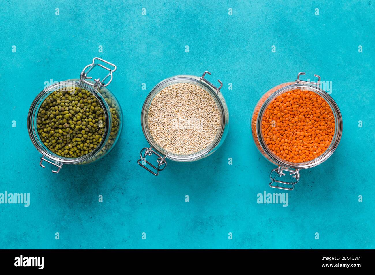 Glass boxes and bottles with mash, rice, lentils organized home simple ...