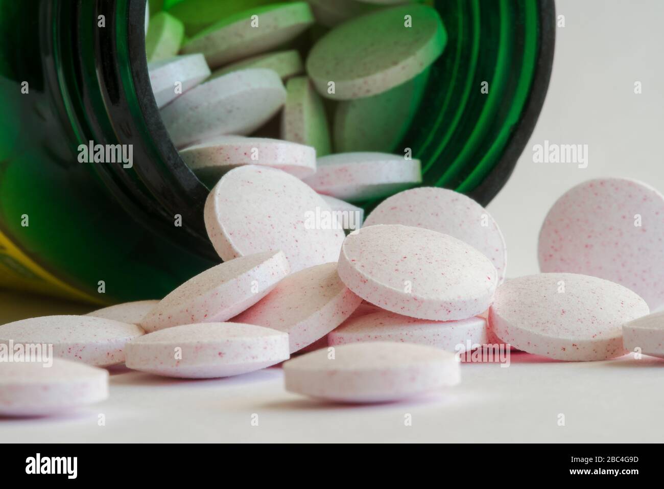Melatonin Pills Spilled from a Bottle Stock Photo - Alamy