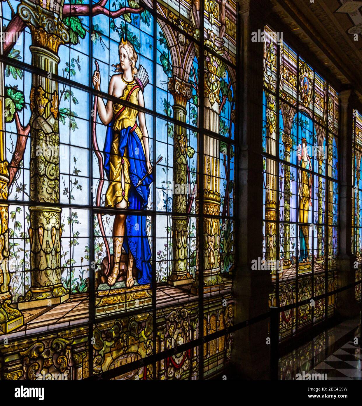 Hallway lined with ornate stain glass murals, at Chapultepec Castle, in ...